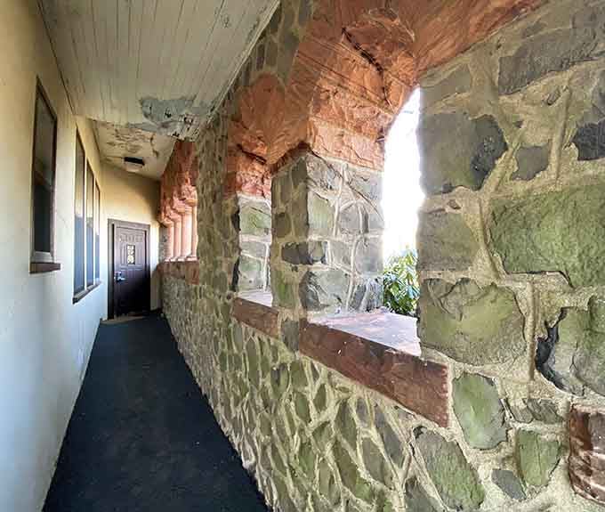 Stone walls, arched openings, and light pouring through. This corridor feels like it belongs in a novel you can't put down.
