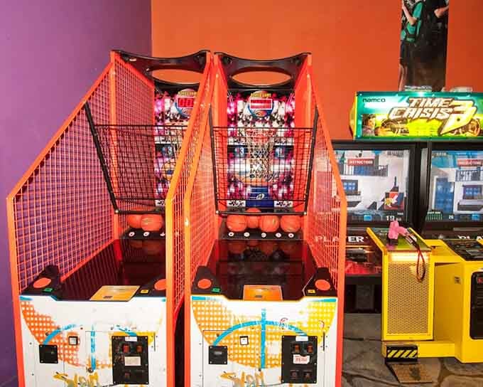 Basketball shooting machines and Time Crisis 3 lined up together, because sometimes you need to drain threes and save the world in the same visit.