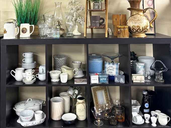 Mugs, vases, candles, and little decorative gems arranged just so, proof that someone here has a genuinely wonderful eye for display.