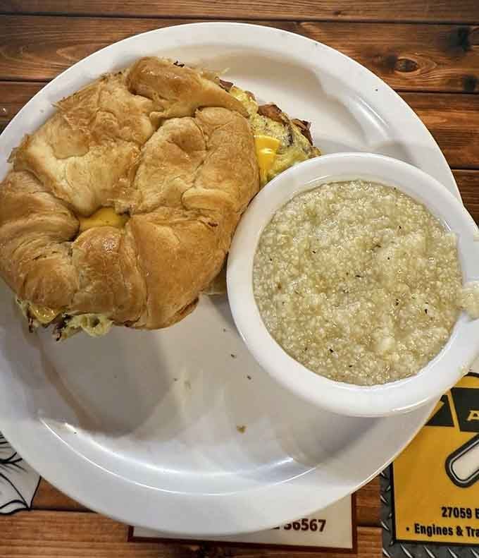 That breakfast sandwich on a croissant paired with grits proves sweet and savory can absolutely coexist peacefully.