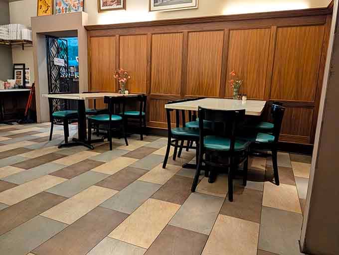 Clean teal chairs, warm wood panels, and fresh flowers on every table, Mama Santa's dining area radiates quiet confidence.