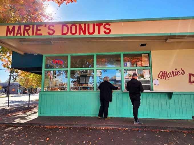 The order window where dreams come true and maple bars change hands faster than concert tickets.