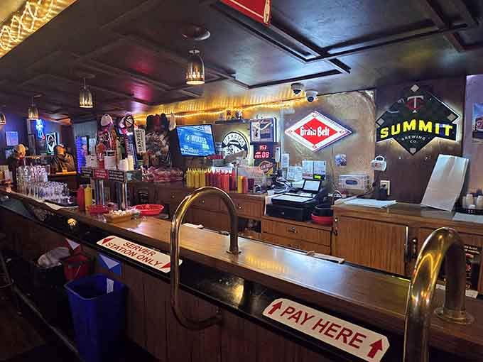 Grain Belt signs, Summit Brewing neon, and a "Pay Here" arrow pointing the way, this bar counter is a love letter to Minnesota.
