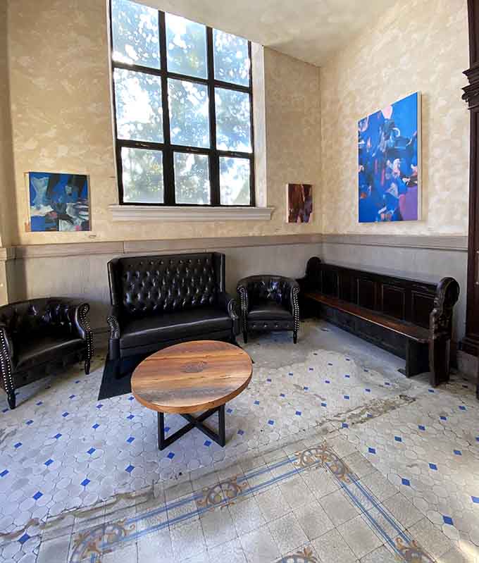 Tufted leather seating and contemporary art prove old buildings can embrace new styles without losing their soul.