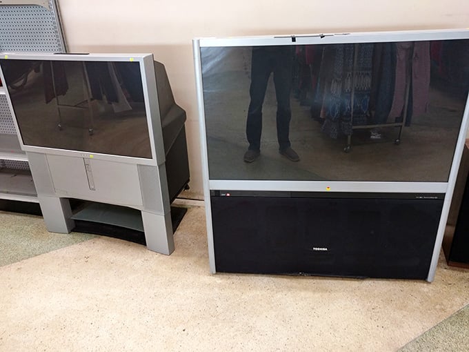 Large projection televisions waiting patiently for a new home, old school entertainment that still gets the job done.