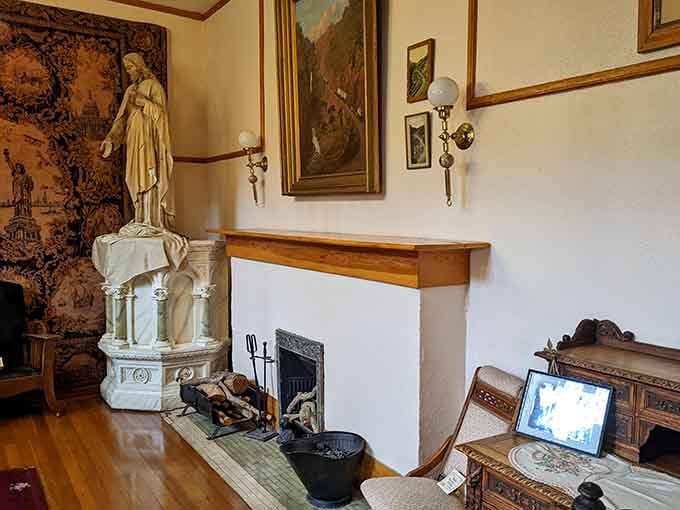 A marble statue, a stone fireplace, and tapestried walls that remind you this was never just an ordinary house.