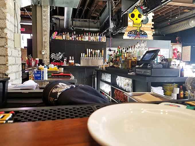 A well-stocked bar with colorful murals and a Day of the Dead figure watching over everything. Good vibes, guaranteed.