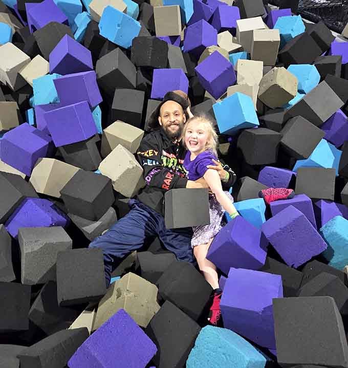 A dad and his daughter laughing together in the foam pit. This is the kind of memory that sticks around forever.