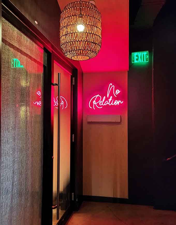 A hot pink neon sign glowing in a dim corridor is the universe's way of saying you made the right reservation tonight.