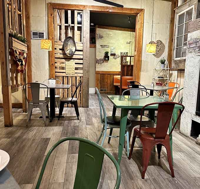 Mismatched colorful chairs and warm wood create a dining space that invites lingering long after your tank is full outside.