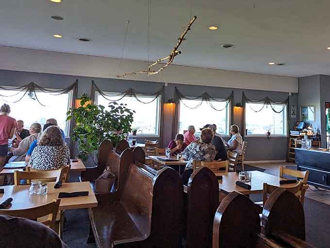 A full, buzzing dining room where the fishing net curtains sway gently and everyone looks like they've already ordered something wonderful.