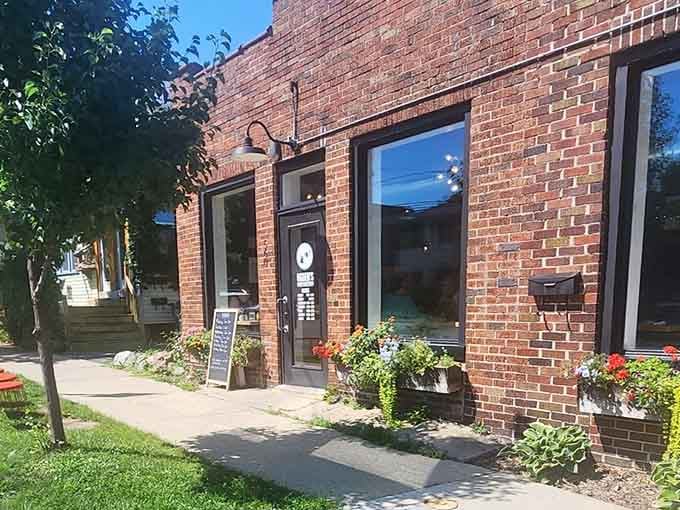 Evening light on brick and flowers signals that this neighborhood gem is worth visiting any time of day.