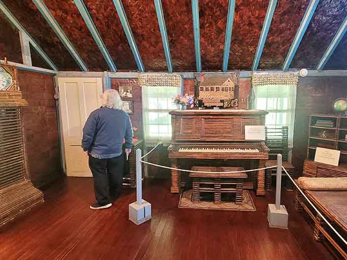 A visitor pauses to take it all in, which is exactly the right response to a piano made of newspaper.
