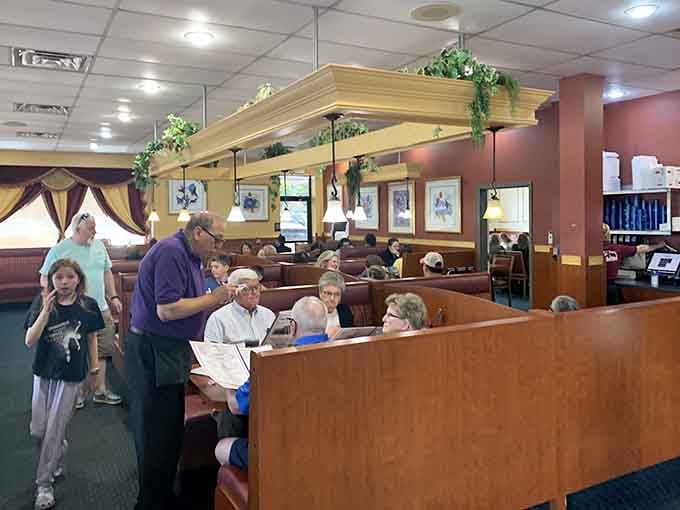 A server leaning in attentively while families settle into booths, this is what genuine hospitality looks like on a Tuesday.