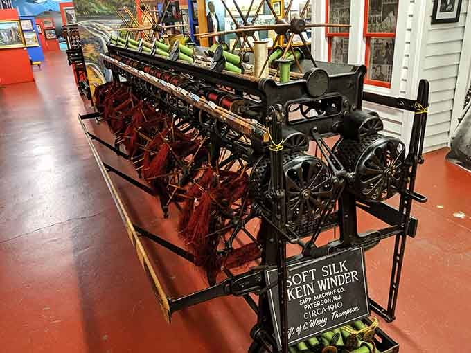 The Sipp Machine Co. Soft Silk Skein Winder from 1910 holds deep crimson silk threads like a treasure chest nobody expected.