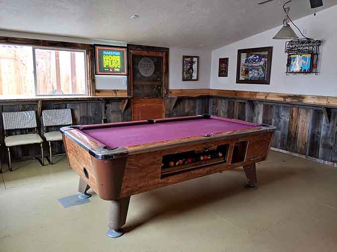 The pool table in the back room, with its purple felt, quietly waiting for someone to make their move.