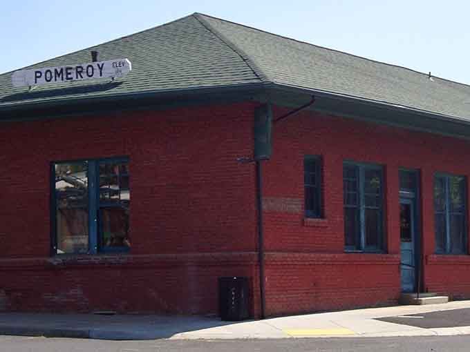 The old Pomeroy Depot wears its red brick and green roof with quiet dignity, a sturdy reminder of the railroad days that shaped this town.