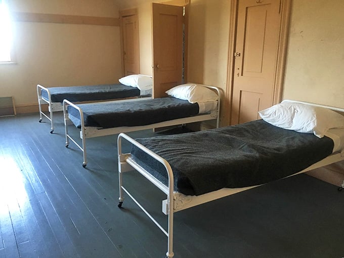 Three simple beds on dark wooden floors. Somewhere between a monastery and a very honest hotel review.