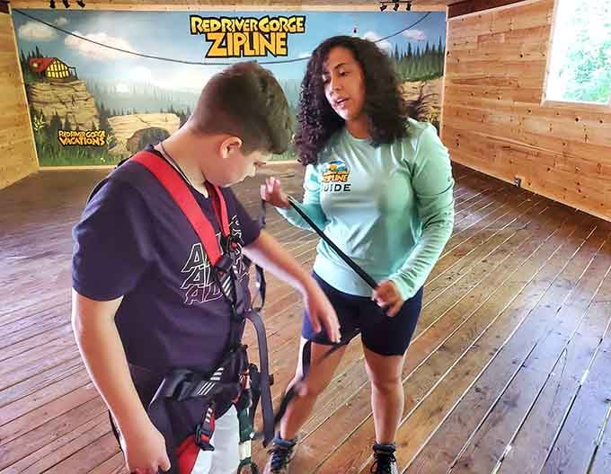 A patient guide fitting a young adventurer's harness, because every great journey starts with the right equipment.