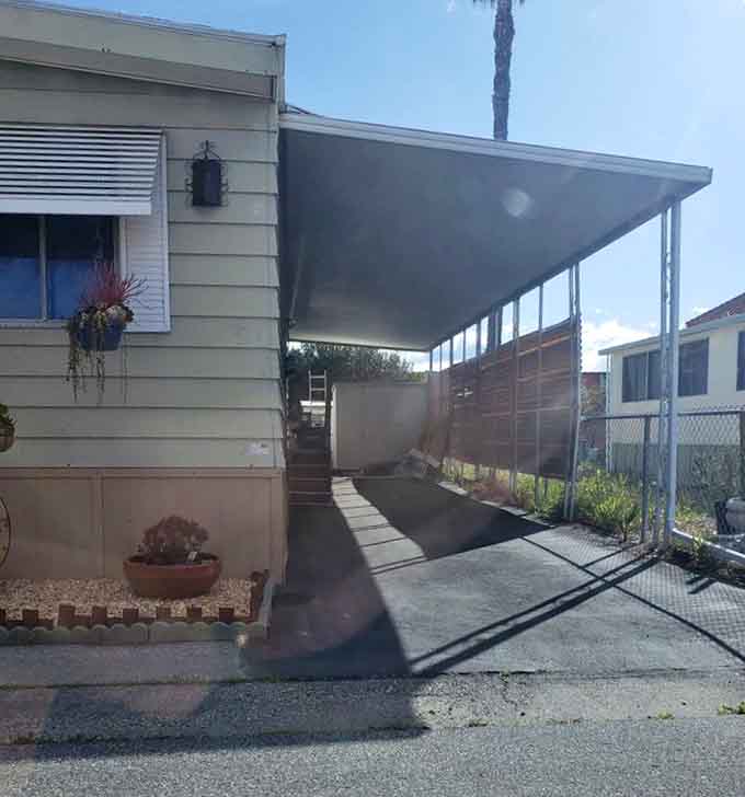 A covered carport and hanging plants, because even your parking spot deserves a little personality.