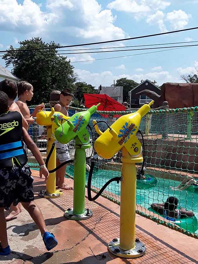 Water guns locked and loaded, these kids are running a very efficient soaking operation with zero apologies.