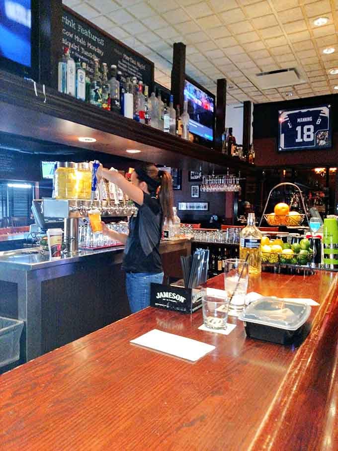 Behind a polished bar stocked with bottles and draft taps, someone's about to make your evening considerably better.