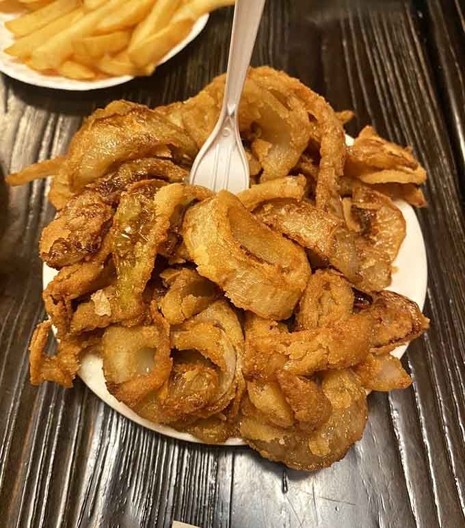 A mountain of homemade onion rings that deserves its own zip code and possibly a national holiday.