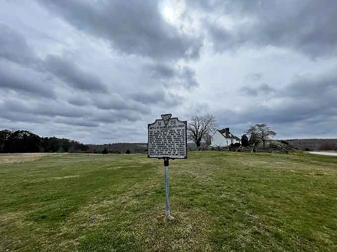Storm clouds gather dramatically behind the battlefield marker, as if the sky itself remembers April 6, 1865.