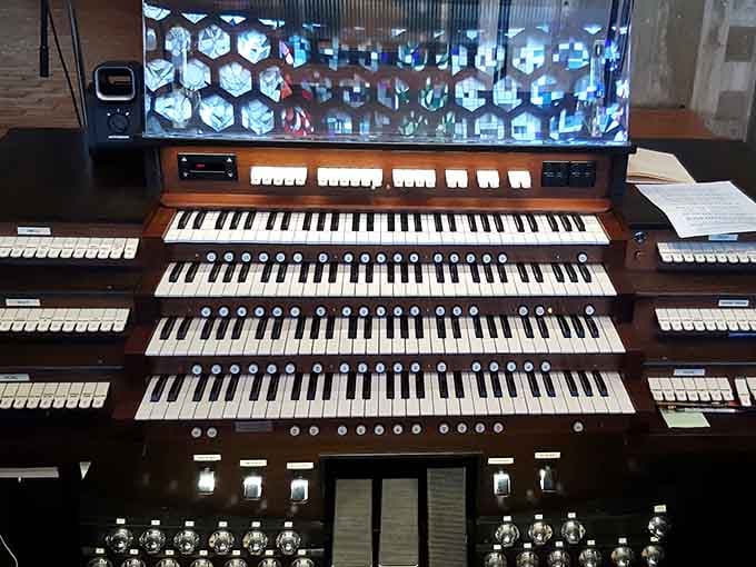 This organ console has more buttons than a spaceship, because apparently making beautiful music requires serious technical firepower and multiple keyboards.