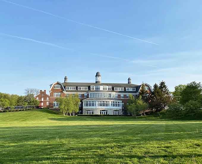 Salisbury School's grand brick building sits on a green hill like it means serious, beautiful business.
