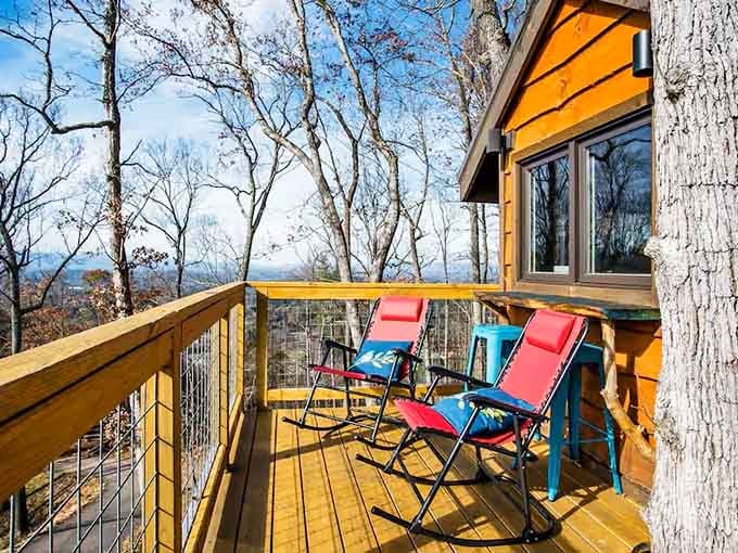 Red rocking chairs on a treehouse deck with mountain views. This is what Saturday mornings were invented for.