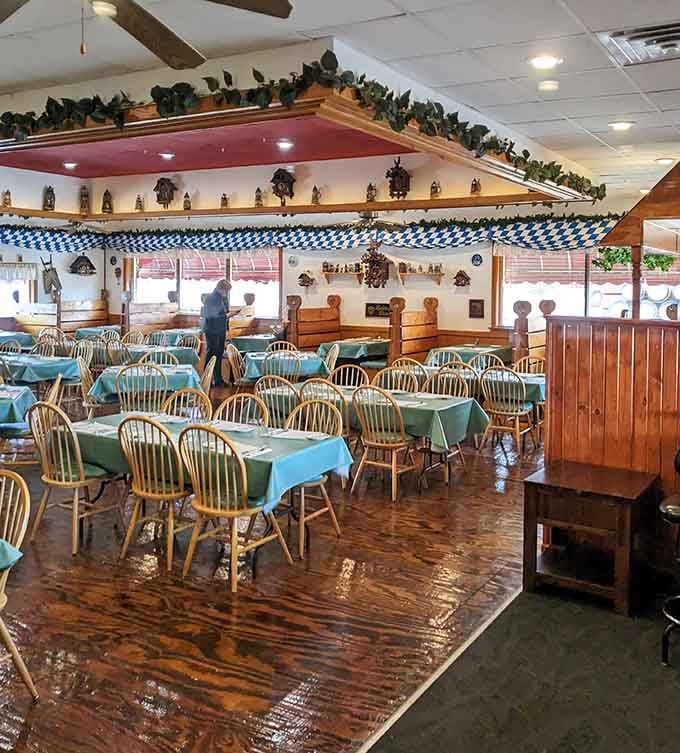 Blue and white Bavarian bunting, cuckoo clocks, and ivy-draped beams overhead. This room transforms an ordinary Tuesday into a mini Oktoberfest celebration.