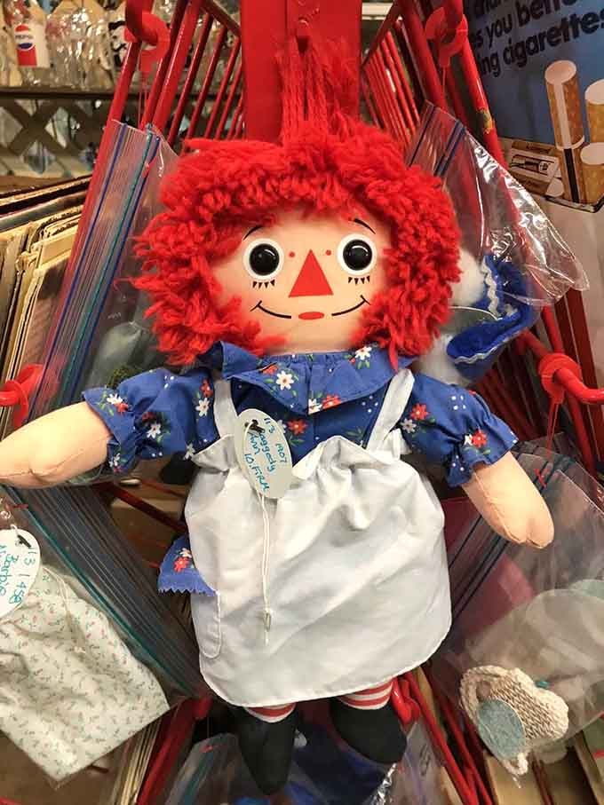 A classic Raggedy Ann doll, red yarn hair and all, patiently waiting for someone to bring her home again.