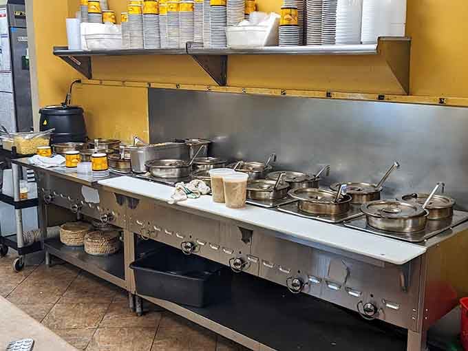 A long stainless steel station lined with pots and pans, quietly doing the serious work behind those 25 daily gallons of greatness.
