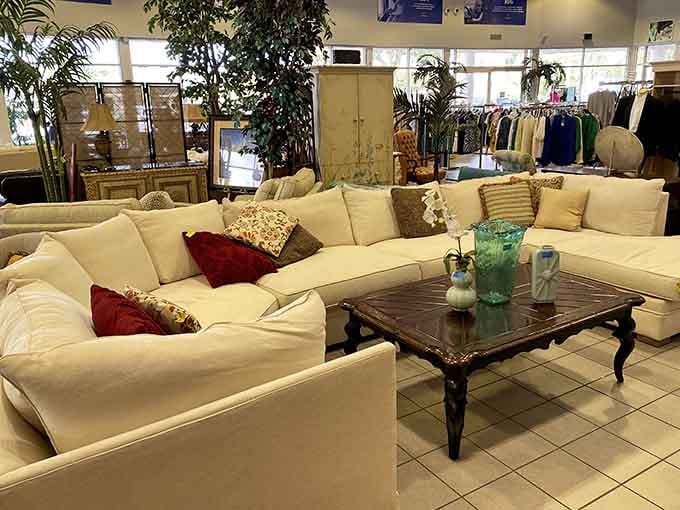 That cream sectional with jewel-toned pillows could anchor your whole living room for pennies on the dollar.