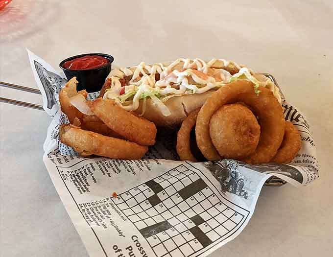 A shrimp po'boy with onion rings on the side, served on newspaper print liner. Classic, casual, and completely irresistible.