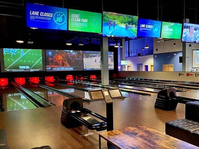 Polished bowling lanes glowing under bright screens, ready and waiting for your best strike of the evening.