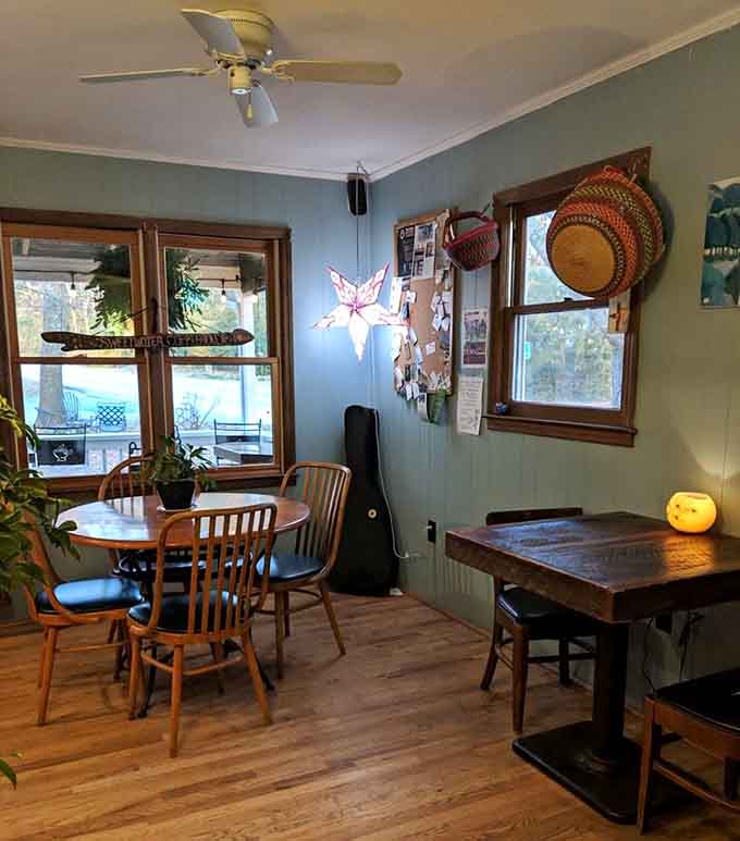 Mismatched chairs, paper star lanterns, and windows full of trees, this dining room feels like a friend's living room, but better.