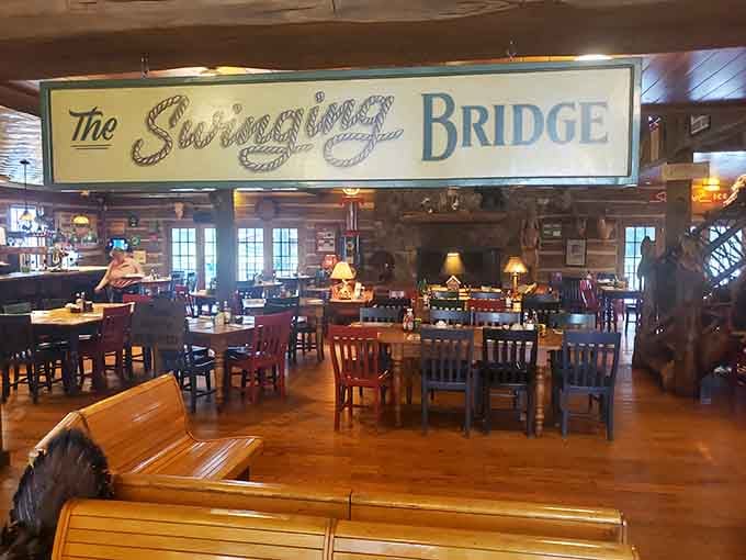That hand-painted Swinging Bridge sign stretching above the dining room says everything. You've arrived somewhere genuinely worth the drive.