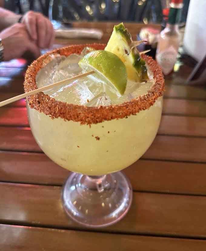 A spicy-rimmed margarita with lime and pineapple garnish. Texas sunshine in a glass, with just enough kick to keep things interesting.