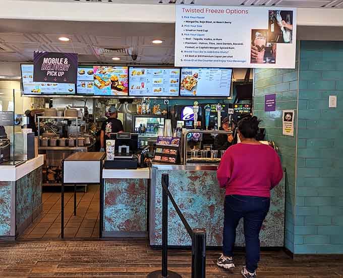 The order counter at Taco Bell Cantina Pacifica, where Twisted Freeze cocktail options greet you before you've even decided on tacos.