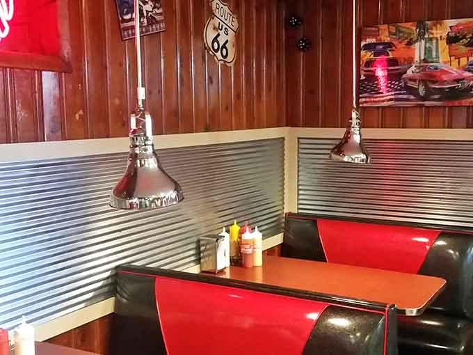 Chrome pendant lights, red vinyl booths, and classic car art. This dining room earns its nostalgia honestly.