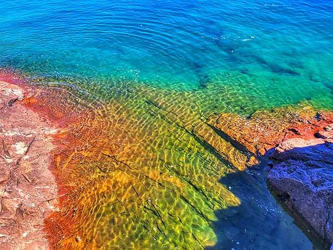 Lake Superior's shoreline rocks glow amber, green, and gold beneath crystal-clear water, looking less like Minnesota and more like the Caribbean.