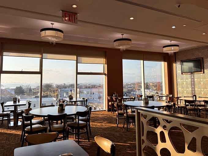 Floor-to-ceiling windows, warm afternoon light, and a view of Queens that pairs beautifully with crab legs.