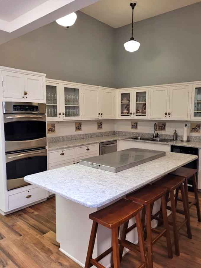 Clean white cabinetry, granite counters, and warm pendant lighting, even the kitchen here has impeccable taste.