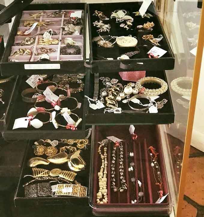 Velvet trays filled with jewelry that carries the quiet confidence of pieces that have already lived interesting lives.