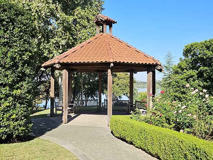 A lakeside gazebo with terracotta roof tiles, the kind of spot where good conversations happen naturally and slowly.