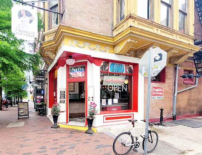 That glowing open sign and cheerful storefront on a sunny afternoon is basically Philadelphia saying, come on in, you deserve this.