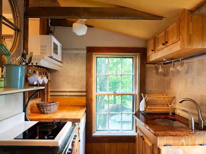 Cozy kitchen, warm wood, and a window view that makes even doing dishes feel oddly pleasant.