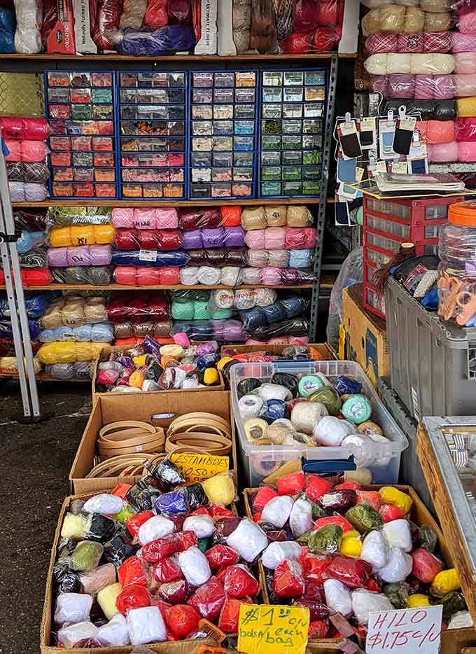 Yarn paradise organized like a rainbow exploded in the best possible way, calling crafters to creative glory.
